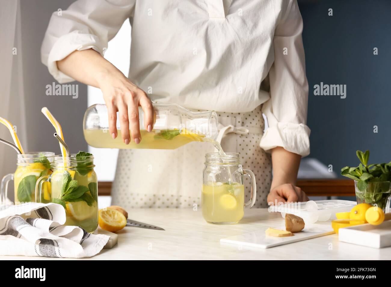 Woman pouring tasty lemonade hi-res stock photography and images - Alamy