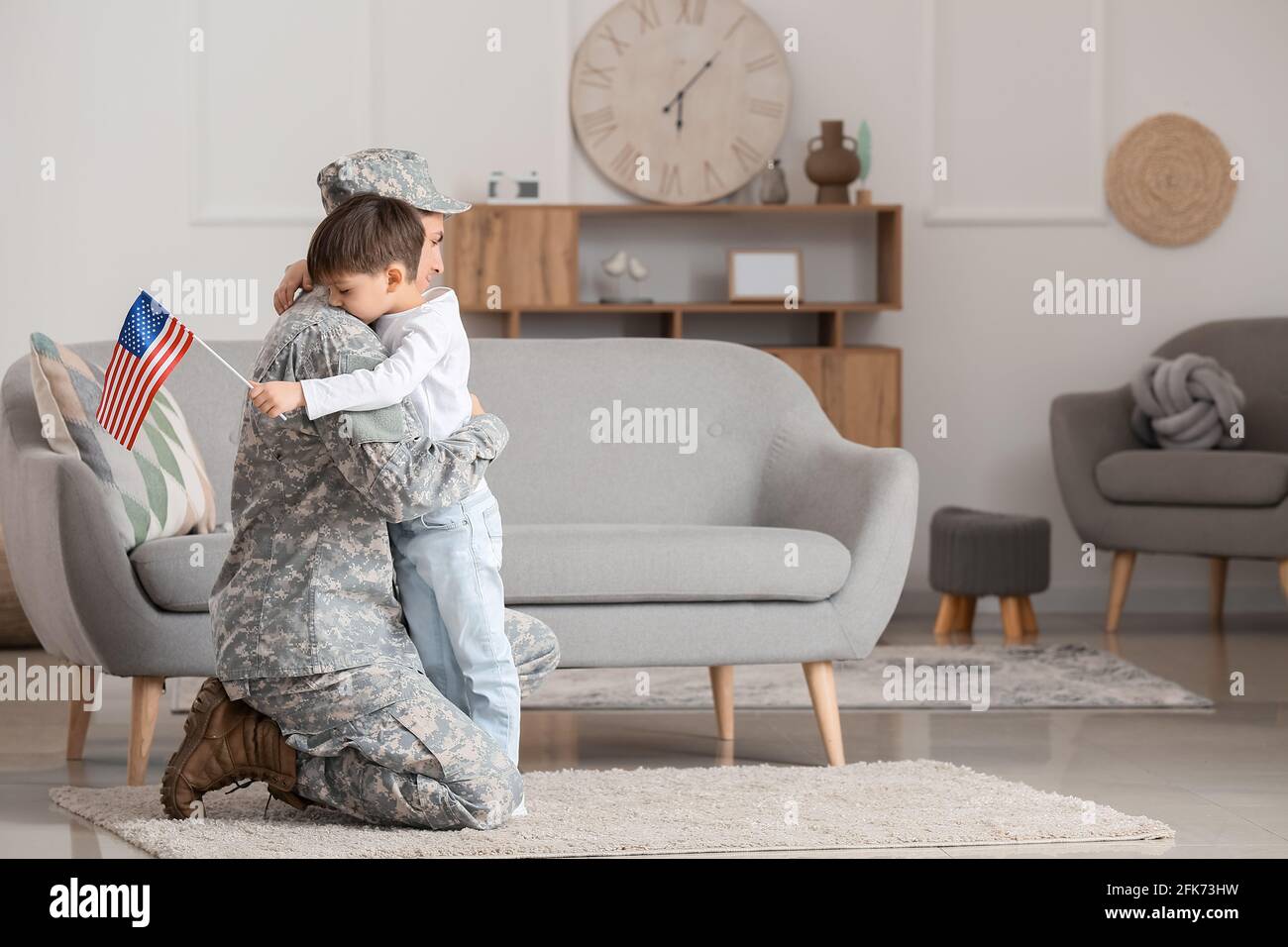 Soldier and his little son hugging at home. Memorial Day celebration ...