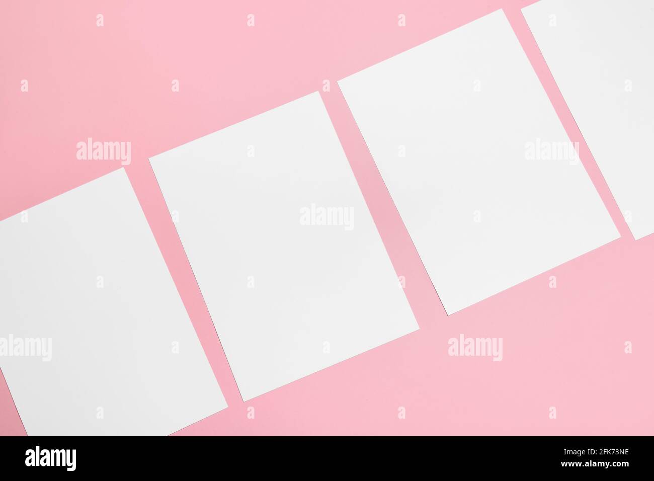 Blank sheets of paper on color background Stock Photo - Alamy