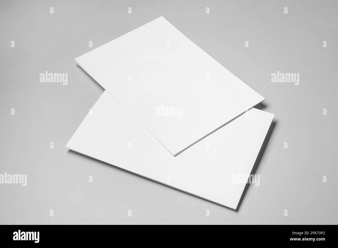 Blank sheets of paper on grey background Stock Photo - Alamy