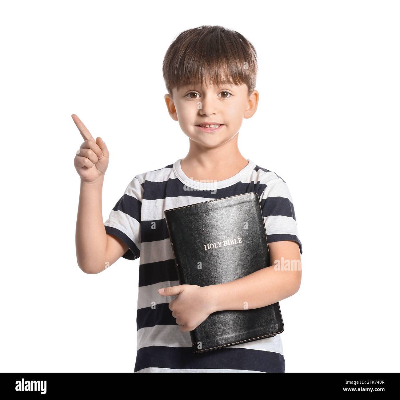 Little boy with Bible pointing at something on white background Stock ...
