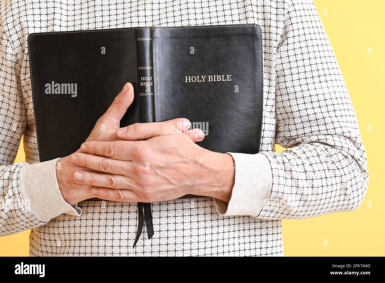 Man with Bible on color background, closeup Stock Photo - Alamy