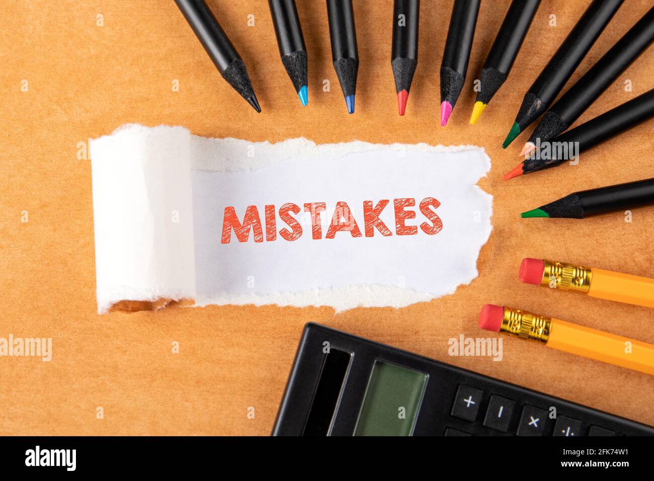 Mistakes. Text under torn paper. Colored pencils on an orange ...