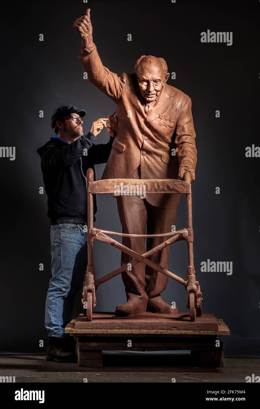 Andrian Melka puts the finishing touches to his two-metre high clay ...
