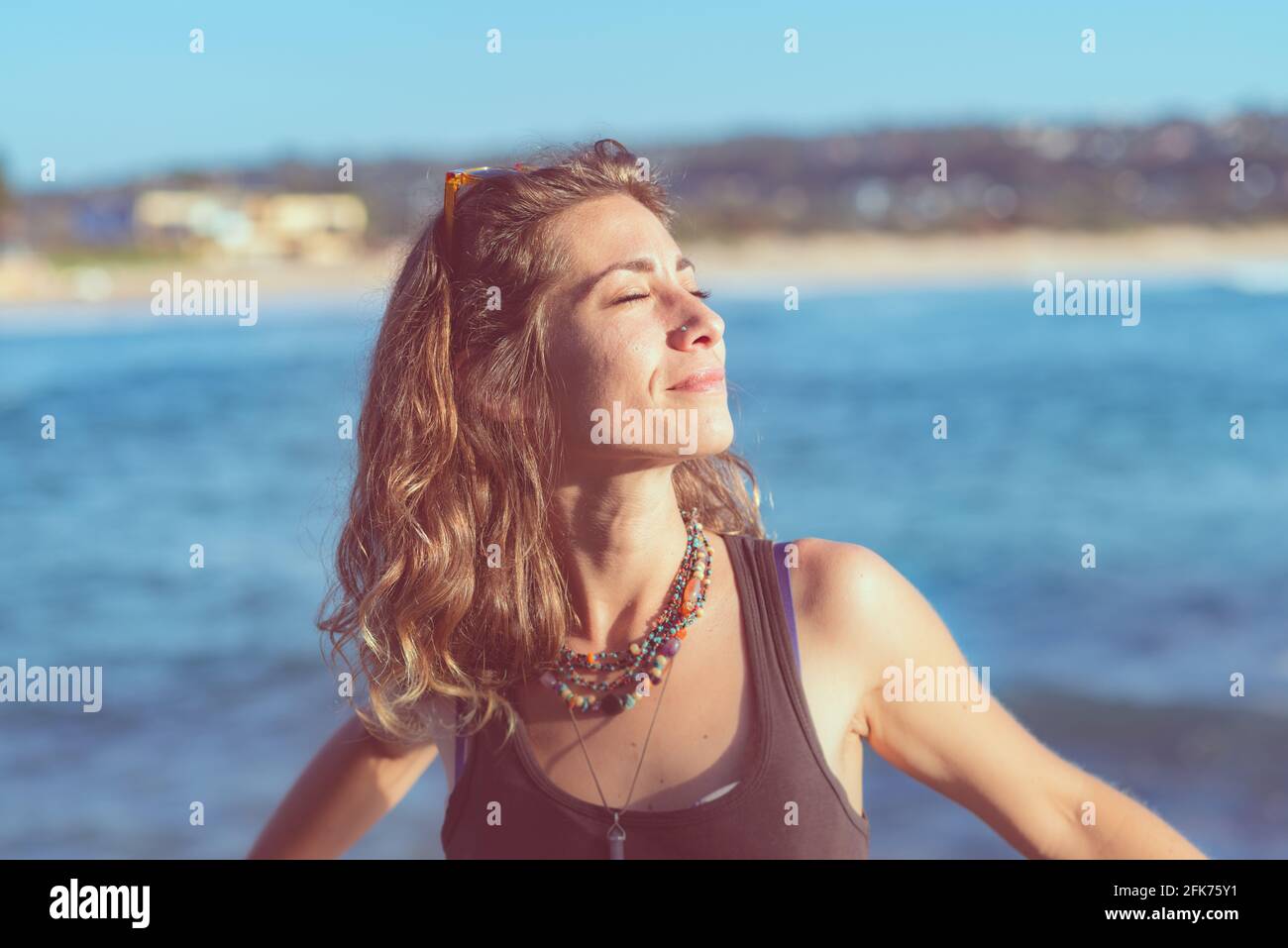 woman standing in the sun near the beach Stock Photo - Alamy