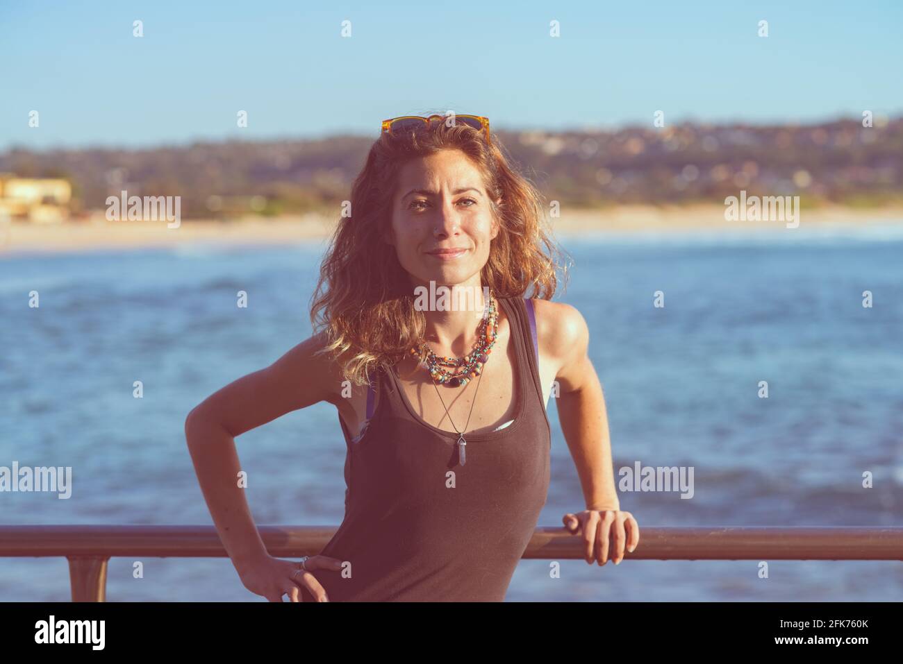 woman standing in the sun near the beach Stock Photo - Alamy