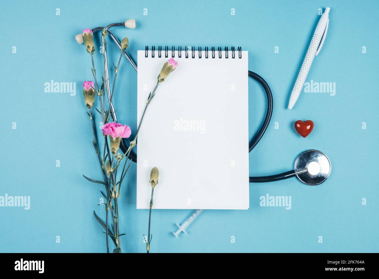 White sheet, medical instruments and flowers on a blue background Stock ...