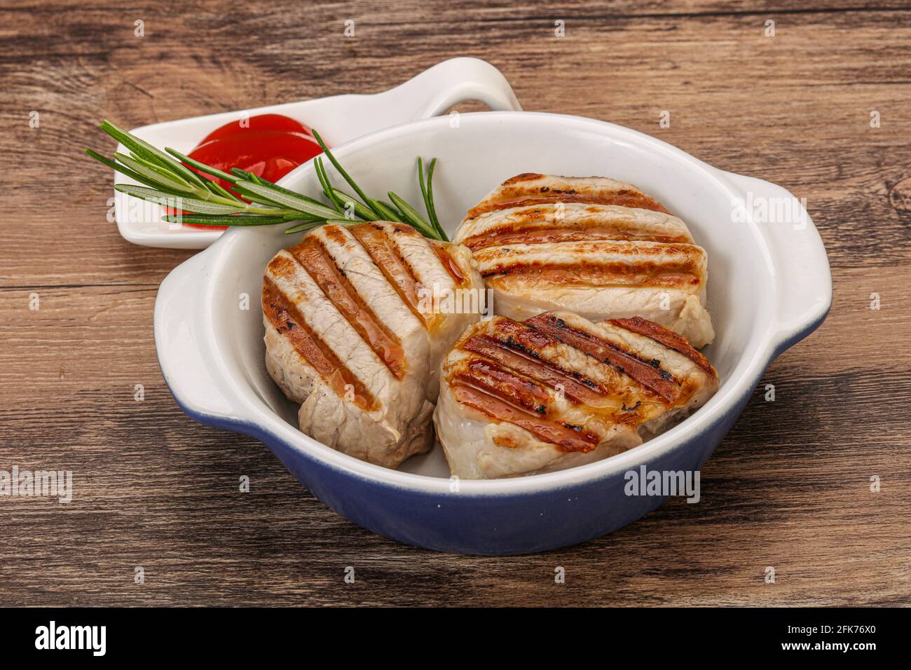 Grilled pork medallion with tomato sauce served rosemary Stock Photo ...