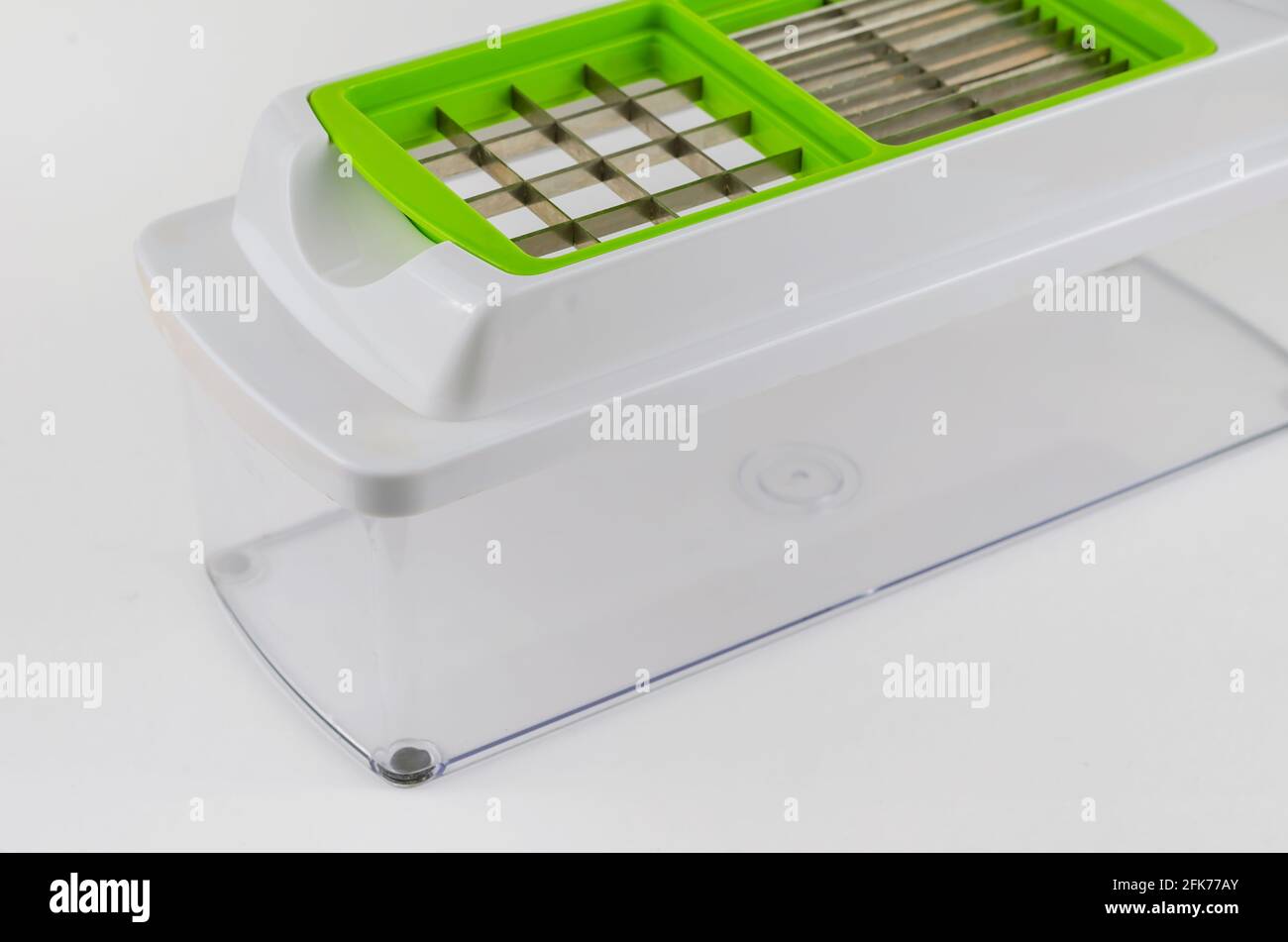 Manual vegetable cutter on a white background. A set of special knives ...