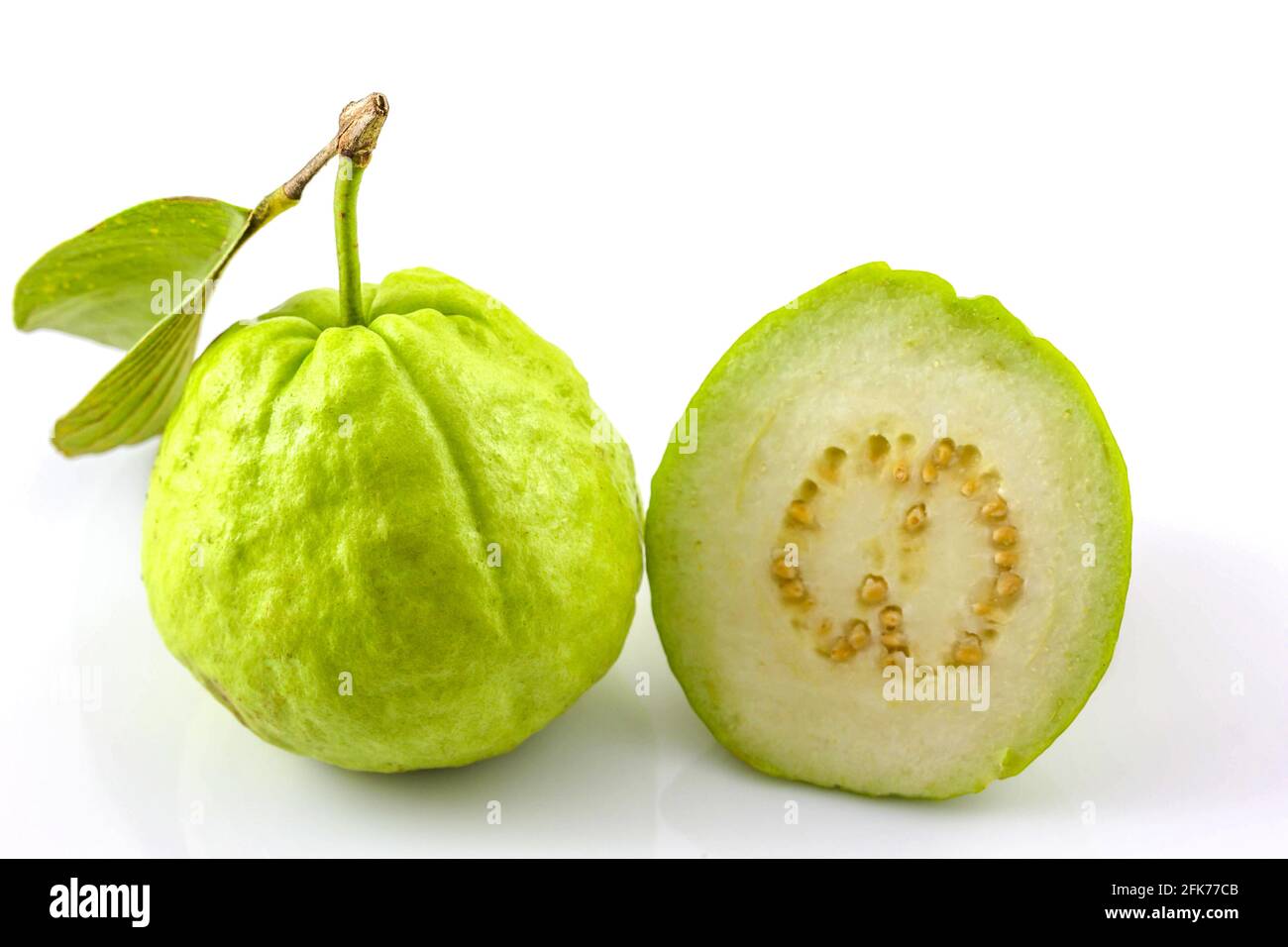 Half guava and slices with the complete one on white background Stock ...