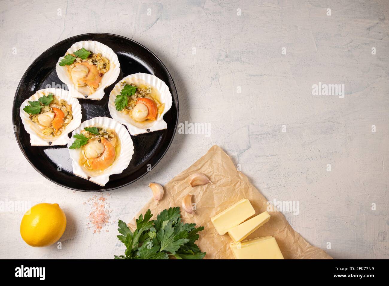 baked scallops with caviar and creamy garlic sauce. Scallops, lemon ...