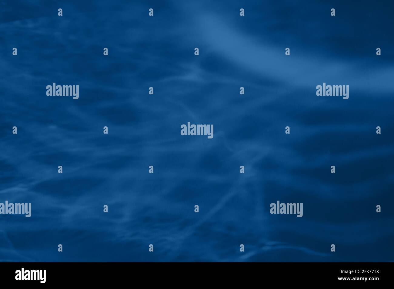 blue colored abstract background with light and shadows caustic effect ...