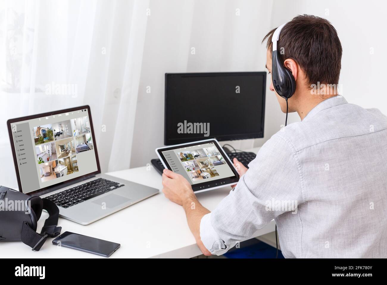man having Home automation control station in a modern home 3D render ...