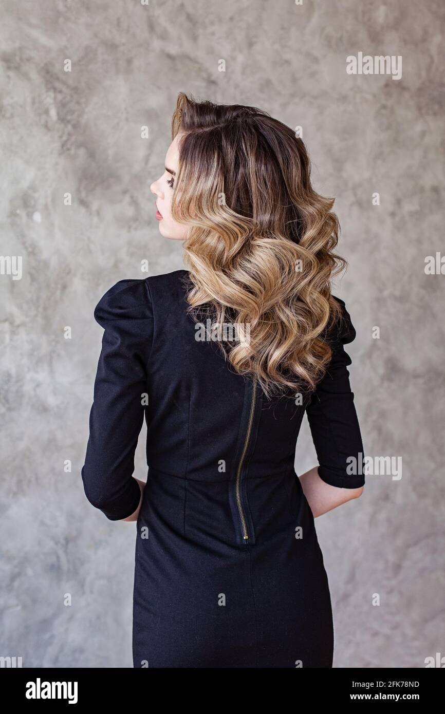 Perfect woman back and head with curly hairdo on gray background Stock ...