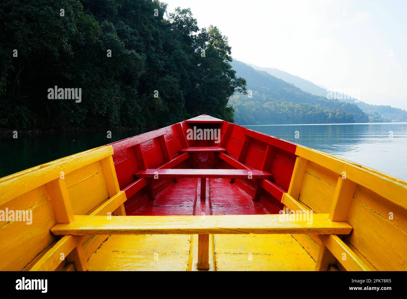 Colorful wooden boat at the shore of beautiful Phewa lake in Pokhara ...