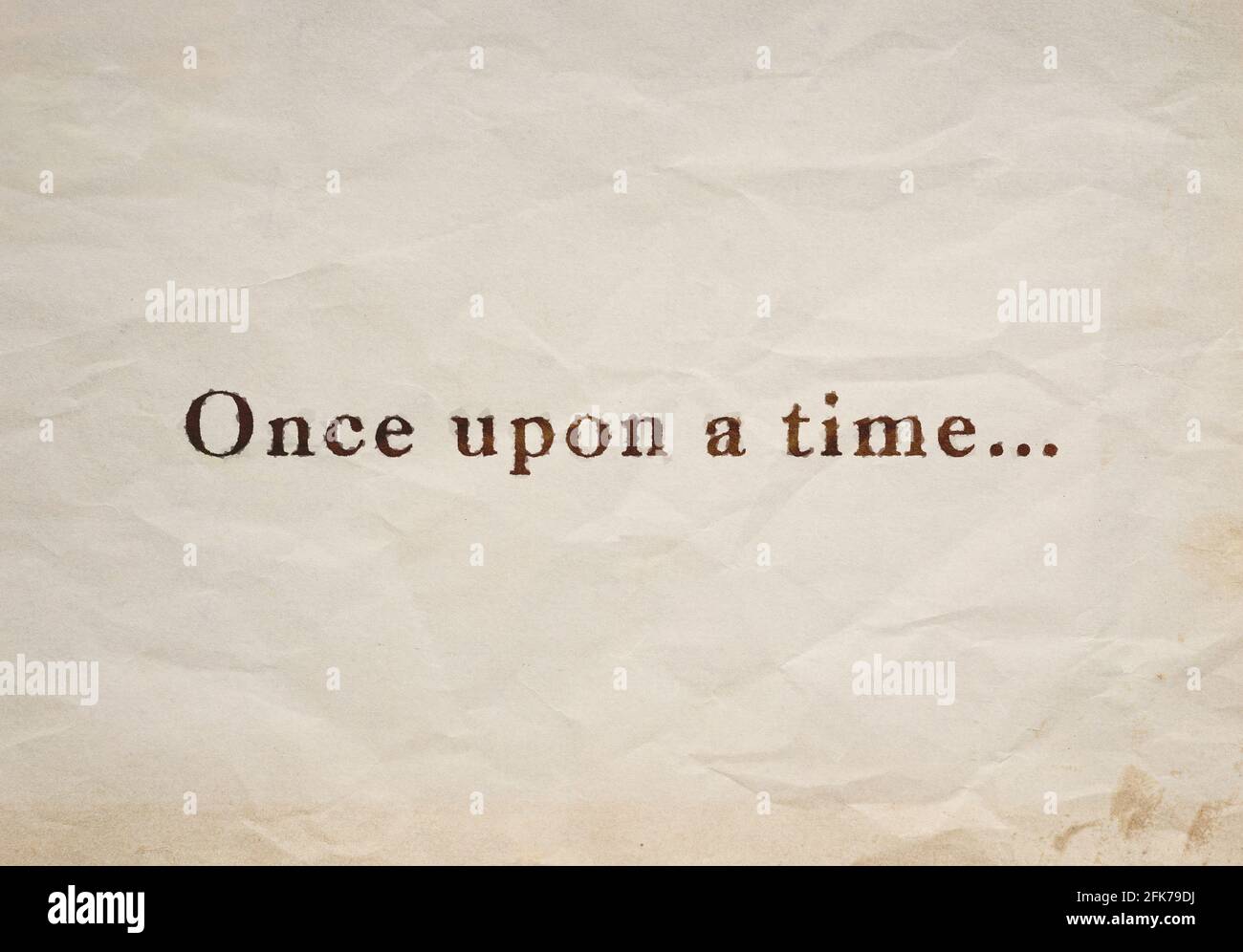 Close-up of "Once upon a time..." text on an old, stained and crumpled ...