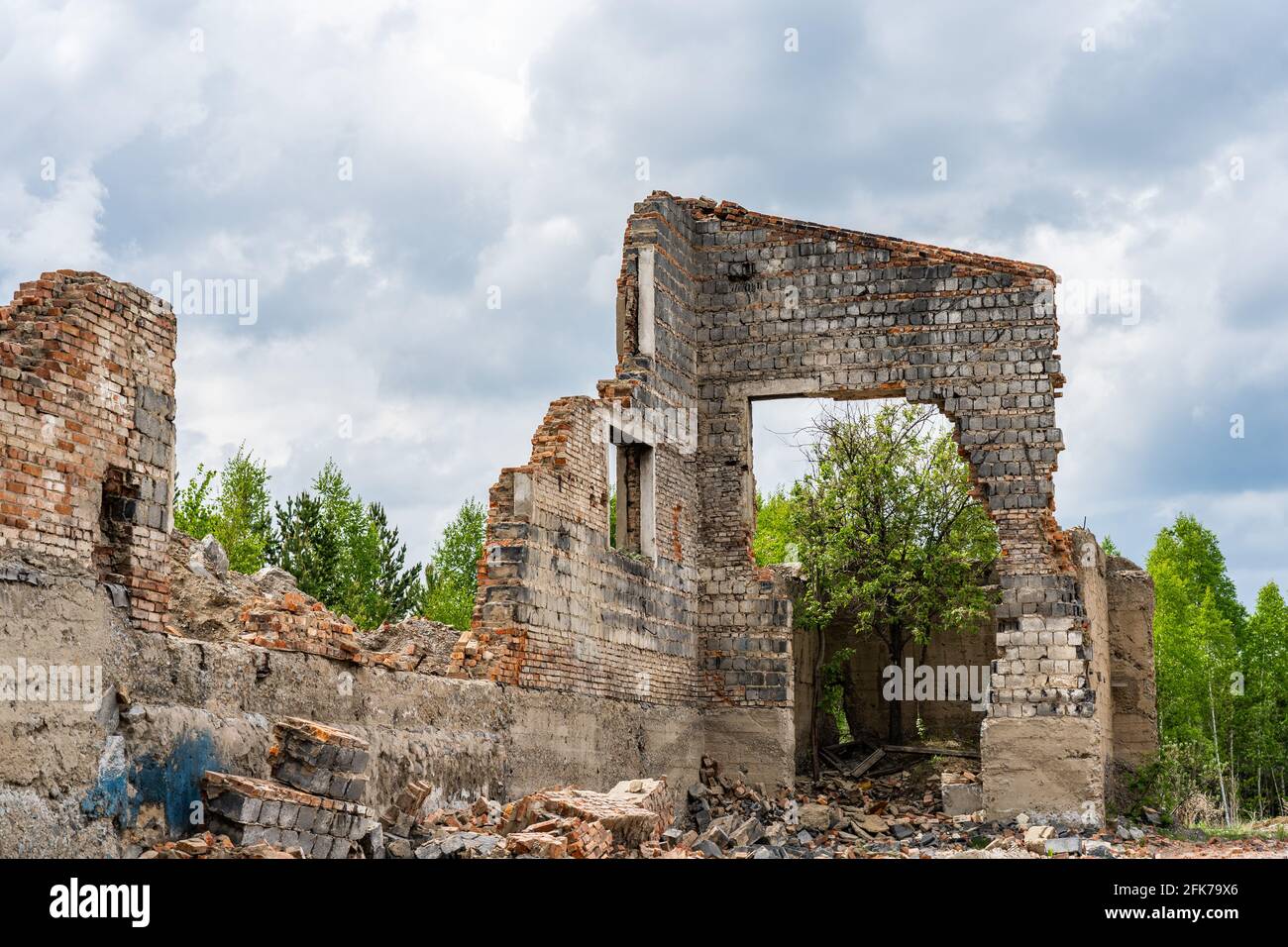 Rift in a brick wall. Close-up. Ruined red brick wall. The wreckage of ...