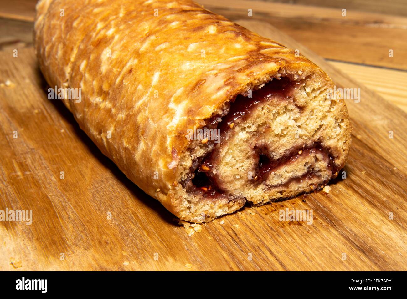 A delicious traditional British Jam Roly-Poly dessert on a wooden ...