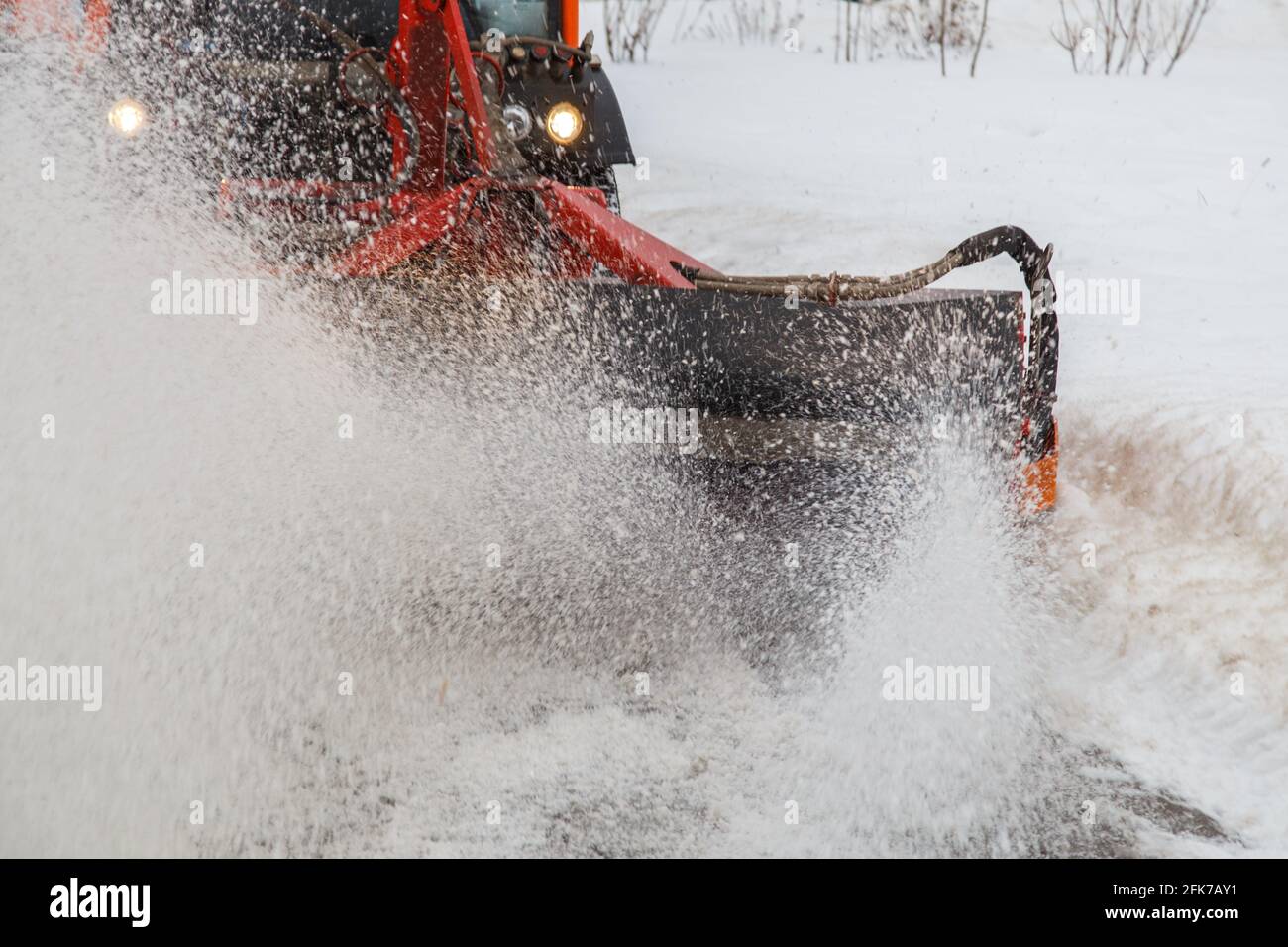 Snow cleaning process at winter city. Snow removal tractor clearing ...