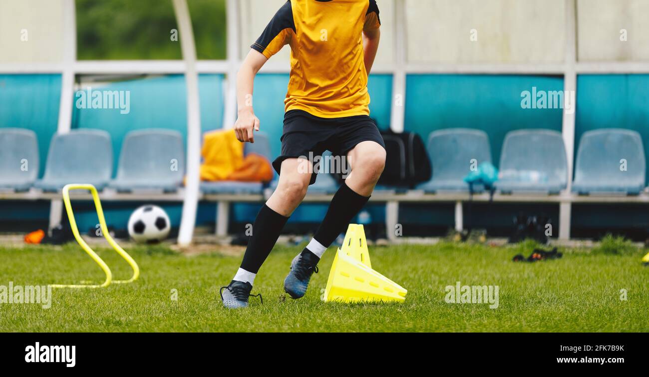 Teenage football player running on training pitch. Young boy practicing ...