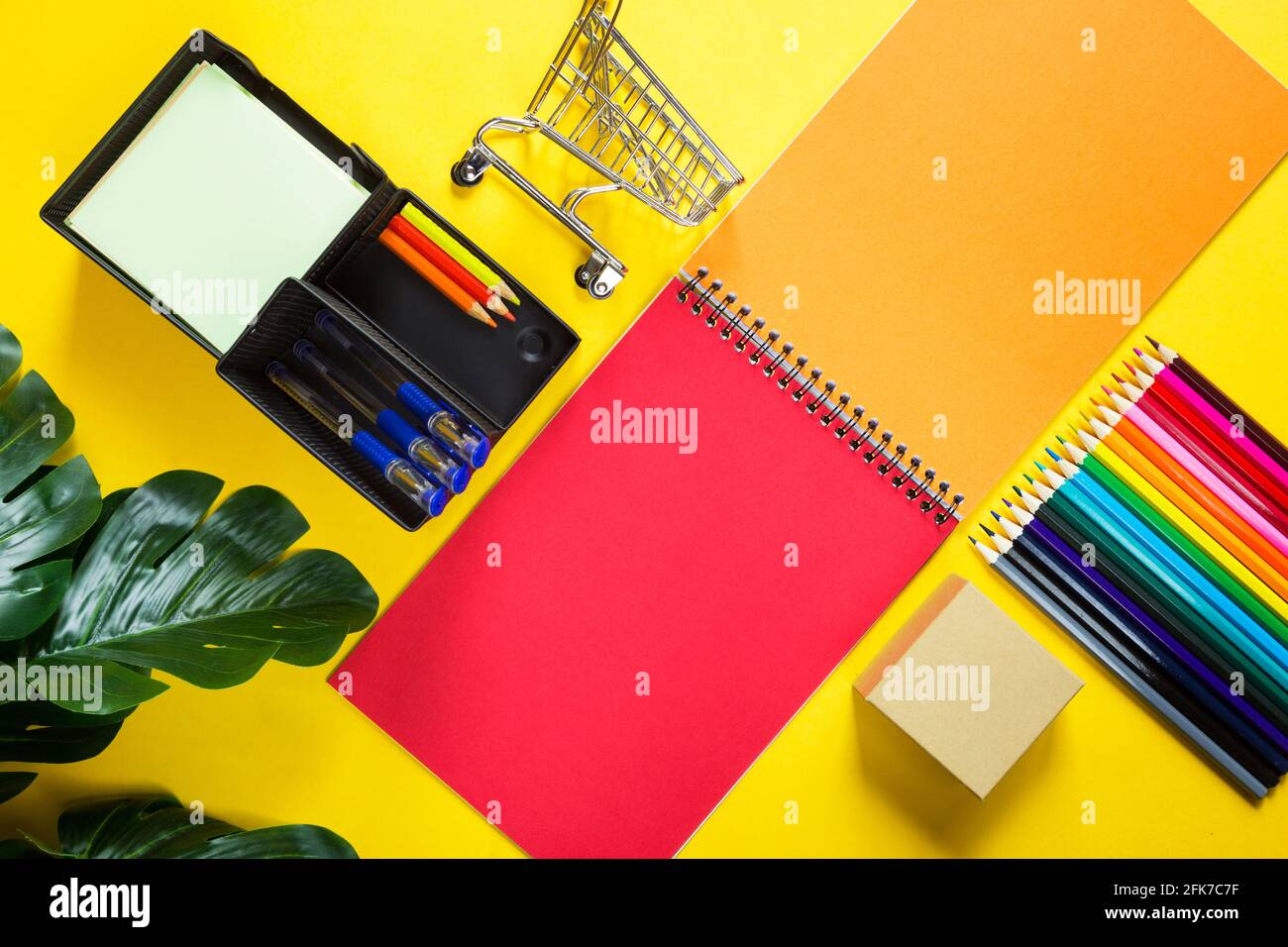 Layout of multi-colored stationery on a yellow background: spiral ...