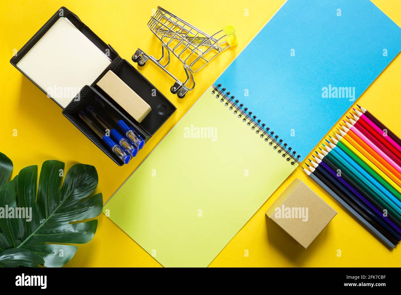 Layout of multi-colored stationery on a yellow background: spiral ...