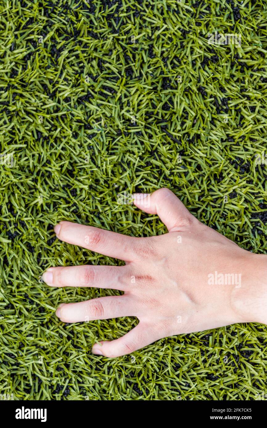 girl hand on soccer field grass background Stock Photo - Alamy