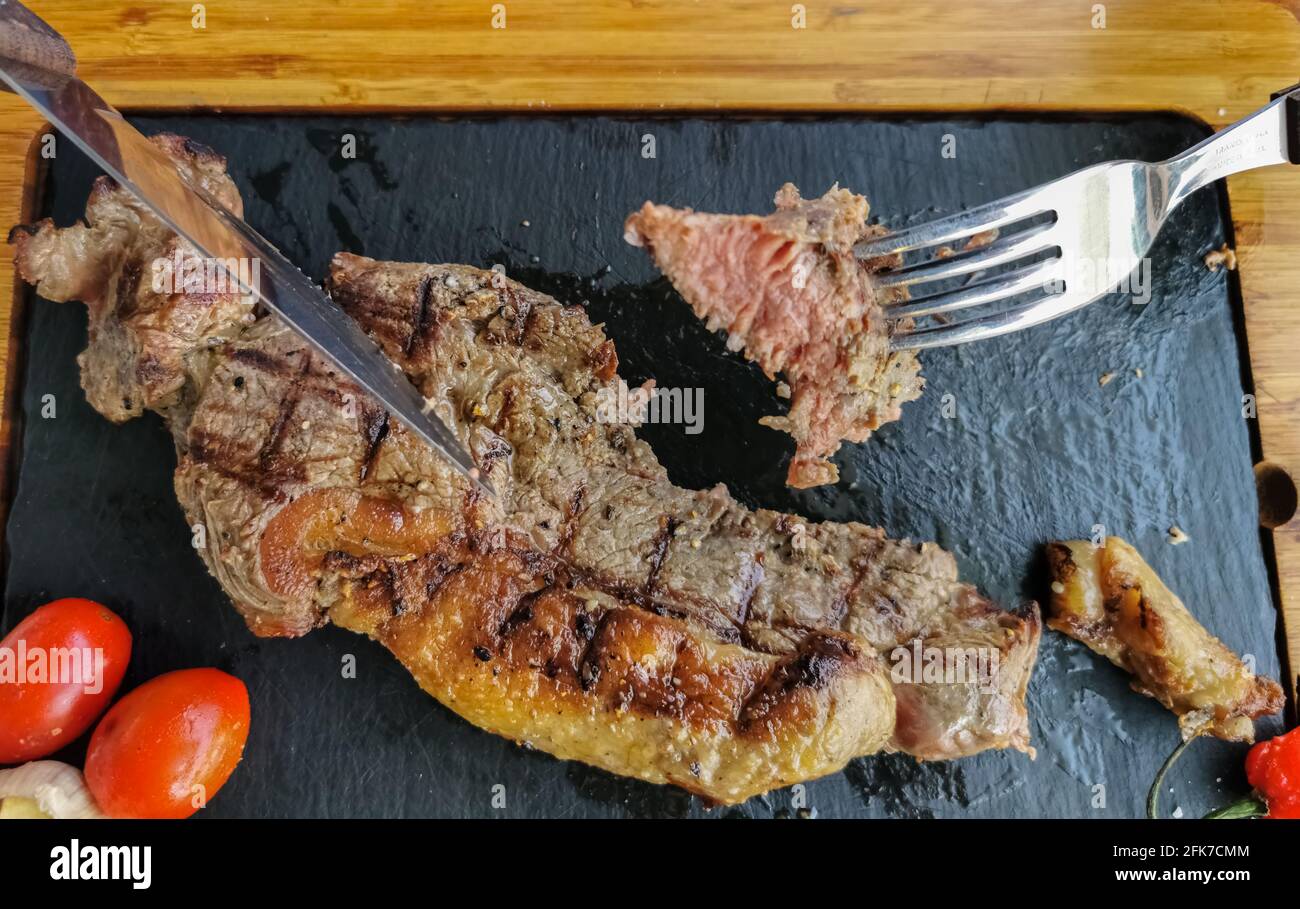 Detailed view of a sliced portion beef on fork, mashed potatoes and ...