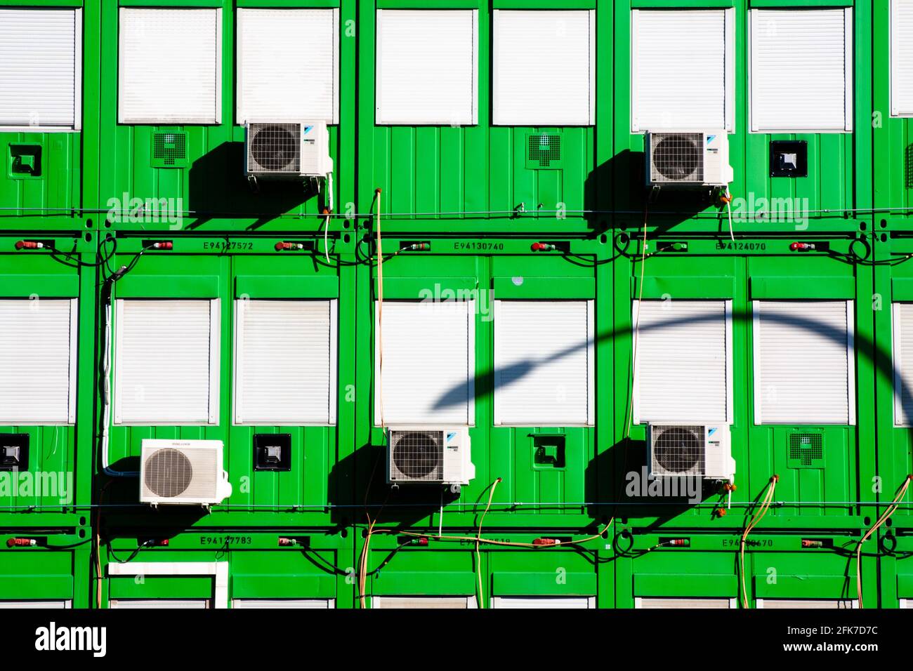 Stacked green containers with air conditioning and blinds Stock Photo ...