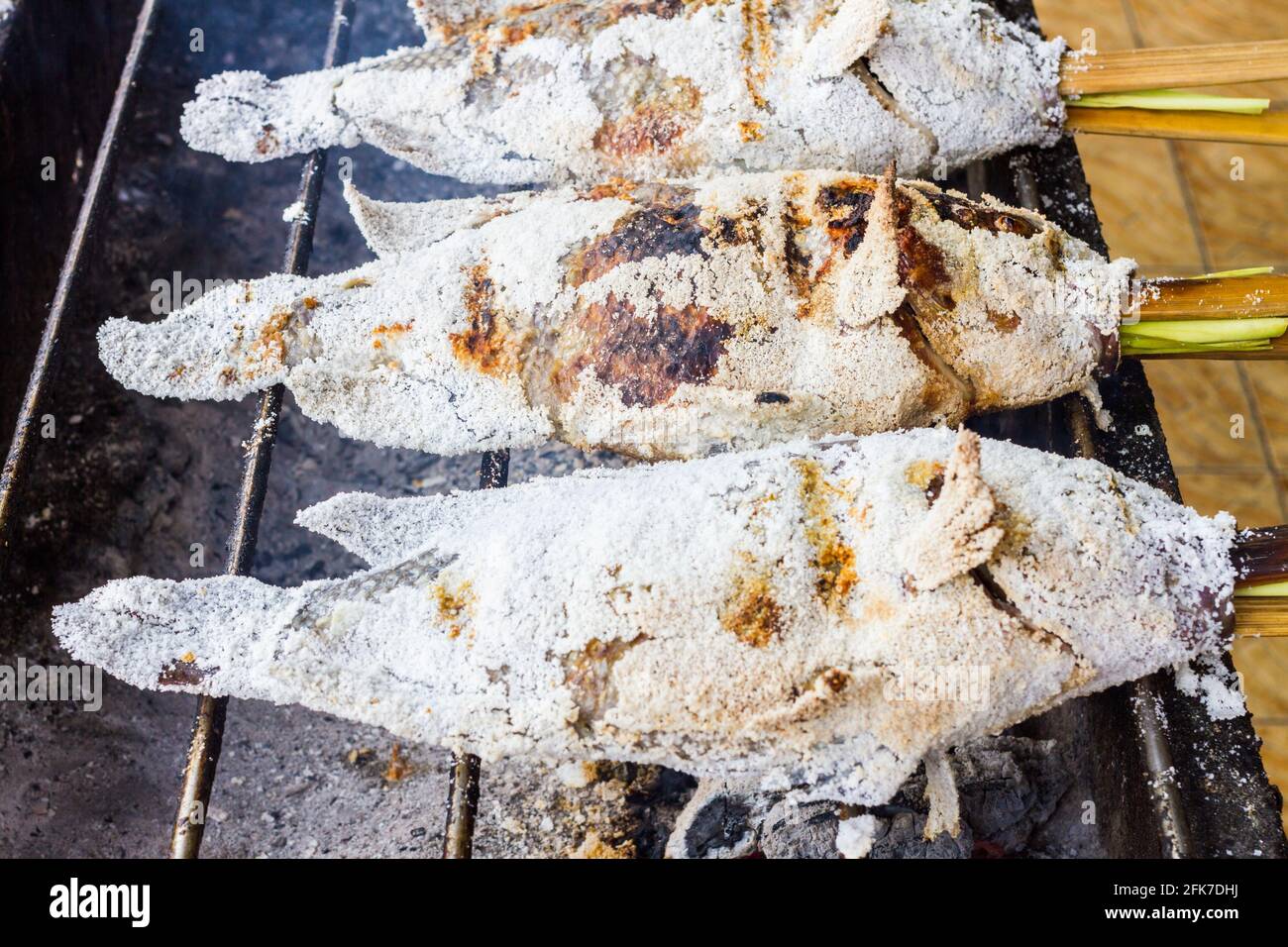 salted grill snakehead fish with herbs food Stock Photo - Alamy