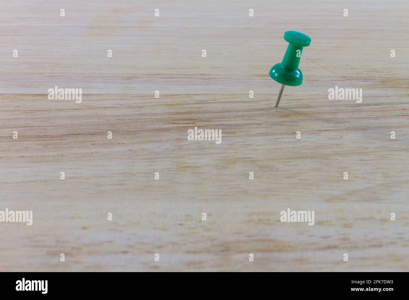 Green pin on the wood background Stock Photo - Alamy