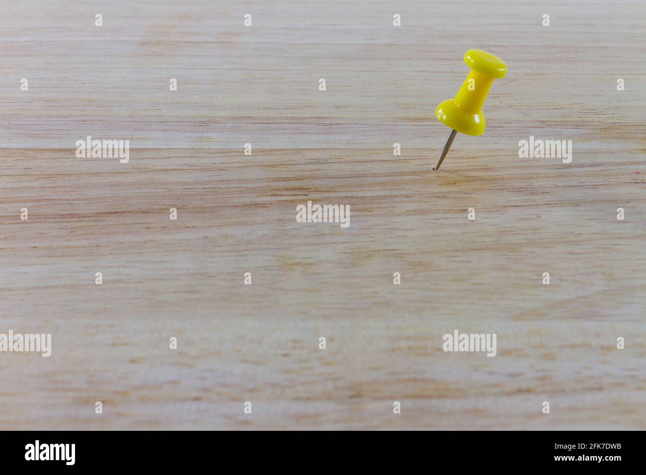 Yellow pin on the wood background Stock Photo - Alamy