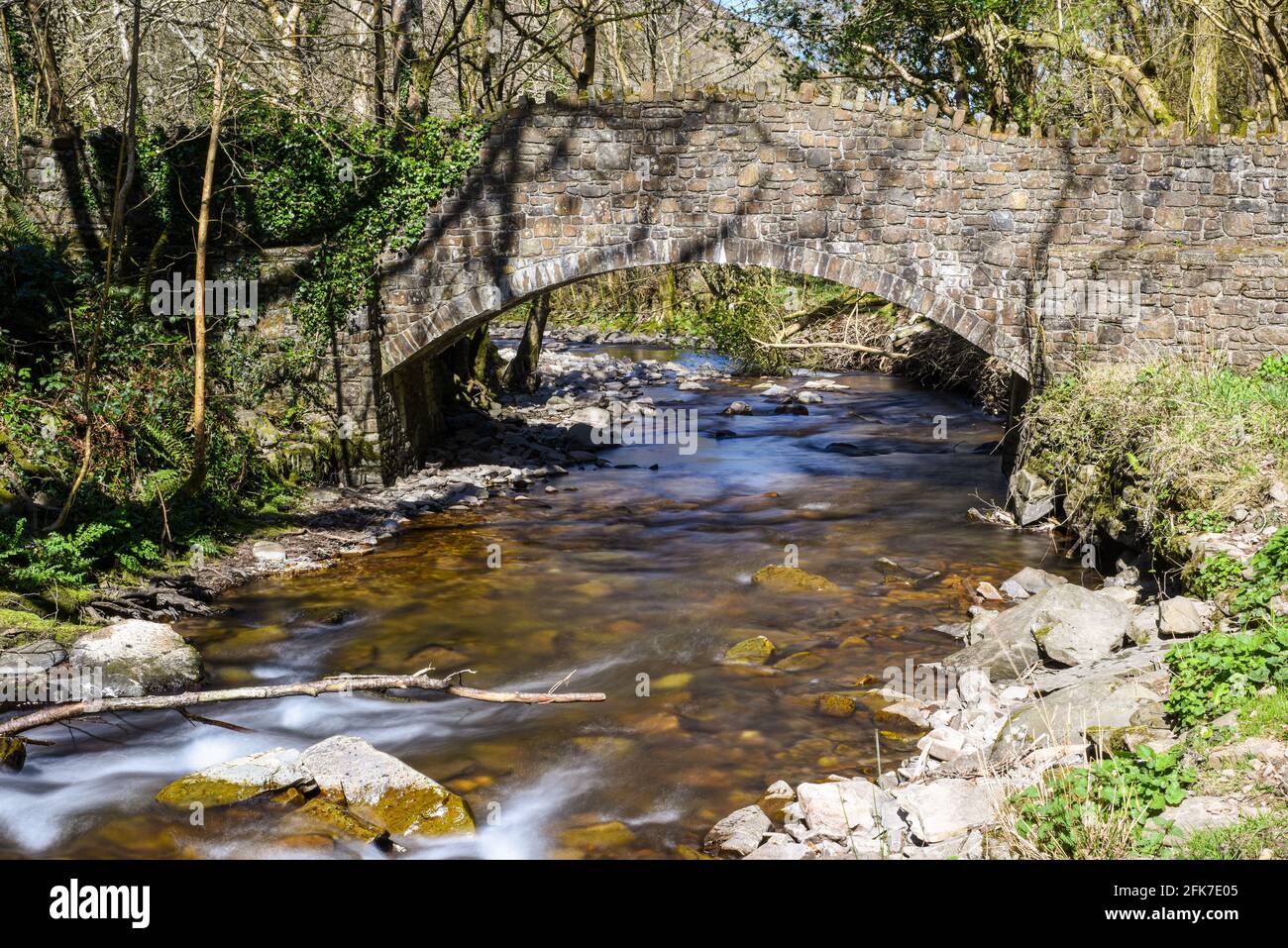 Scenic view of a river flowing under a bridge on a hiking trail in ...