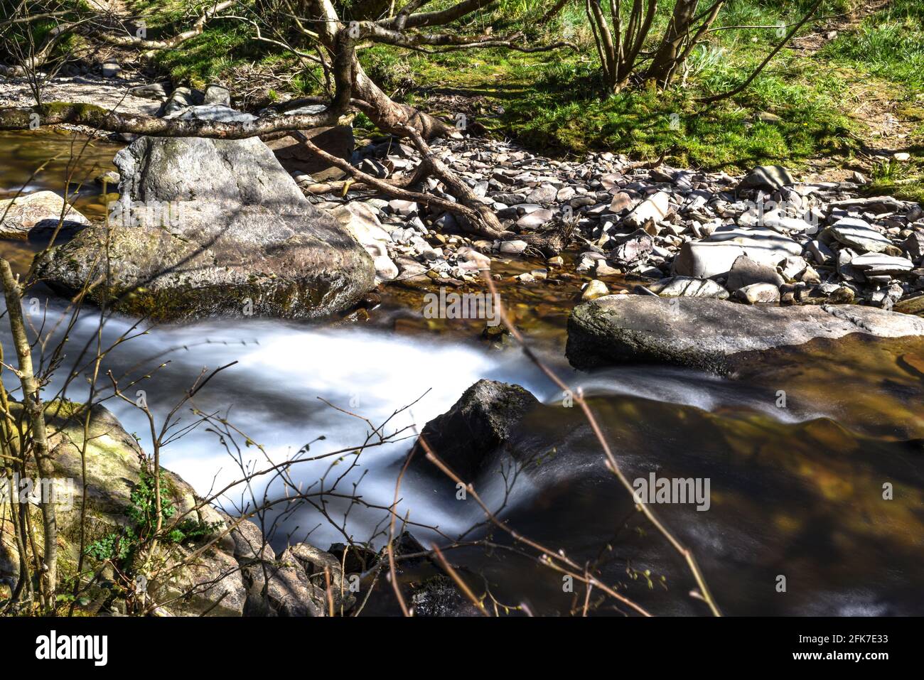 Rushing clear river water splashes over rocks Stock Photo - Alamy
