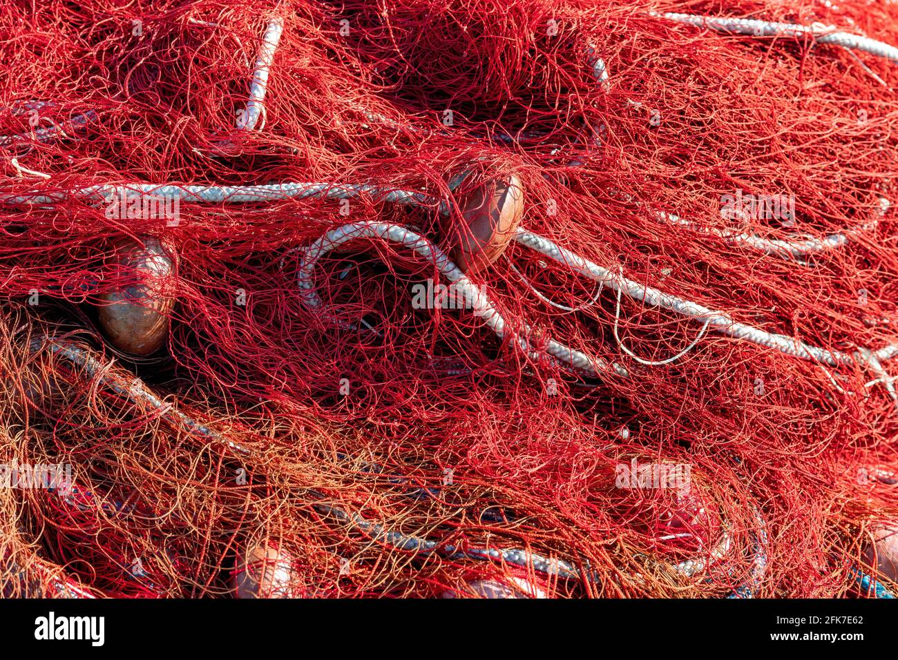 Red fishing nets with ropes and floats. Close-up shot, perfect image ...