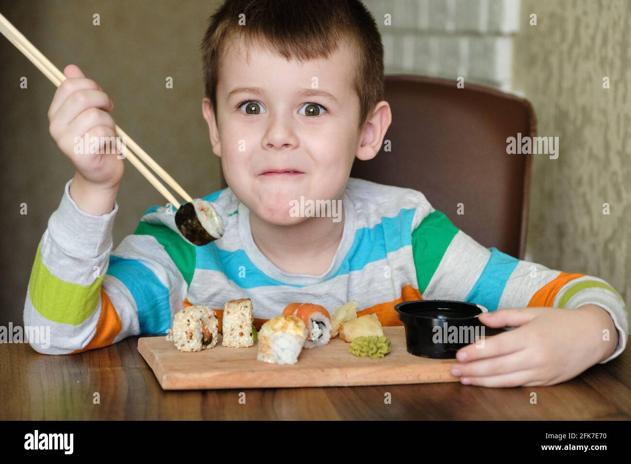 Boy eating sushi roll hi-res stock photography and images - Alamy