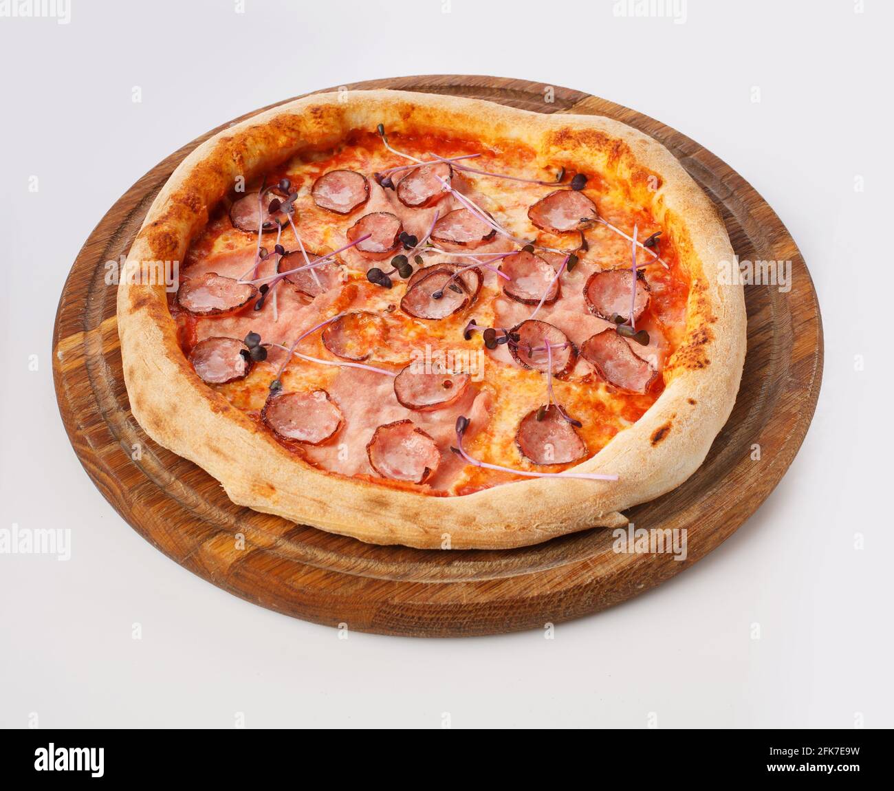 Top view of hot pizza on a wooden stand. Pepperoni pizza. Tomato base ...