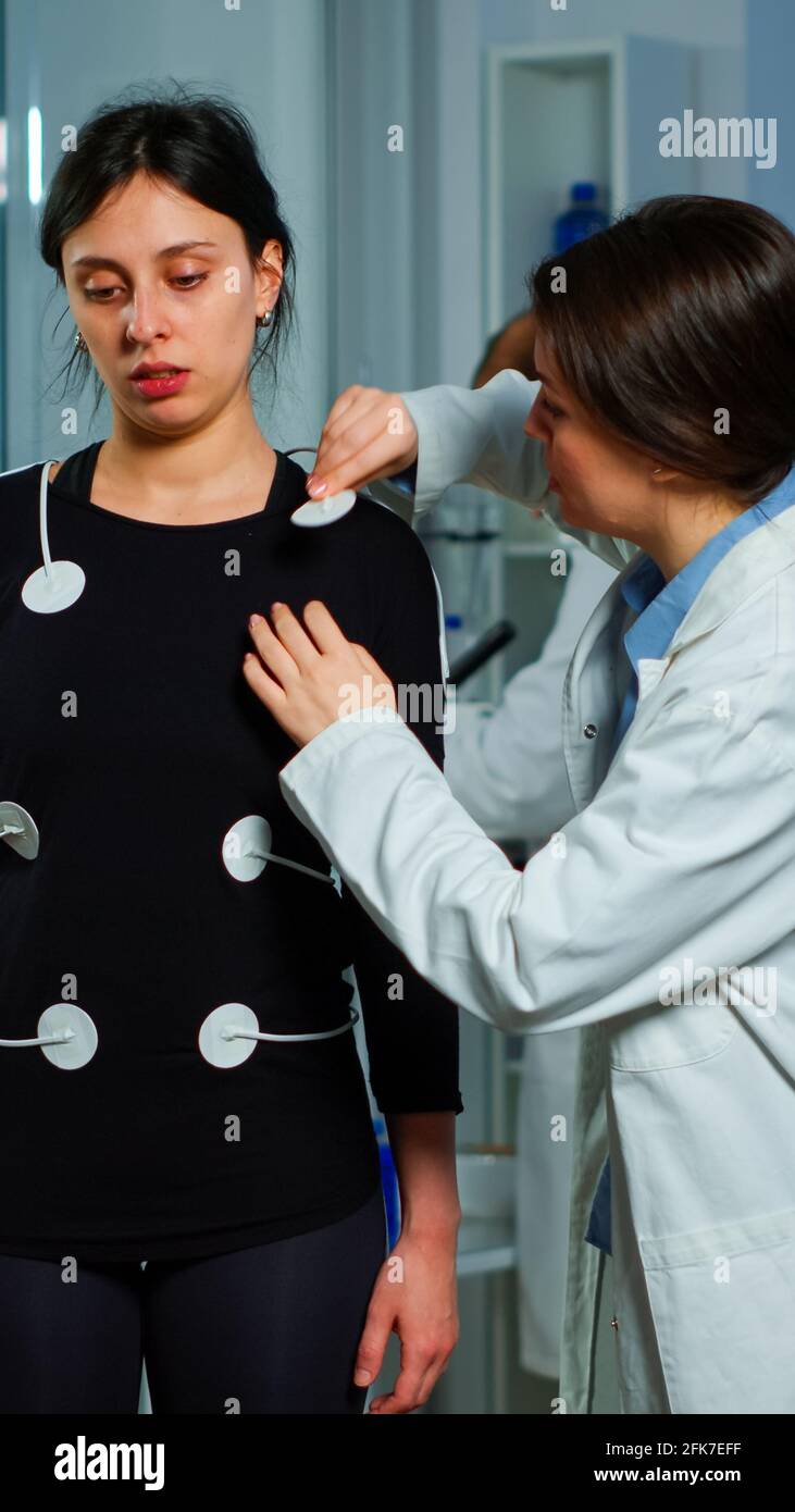 Scientist researcher preparing woman patient for endurance test ...