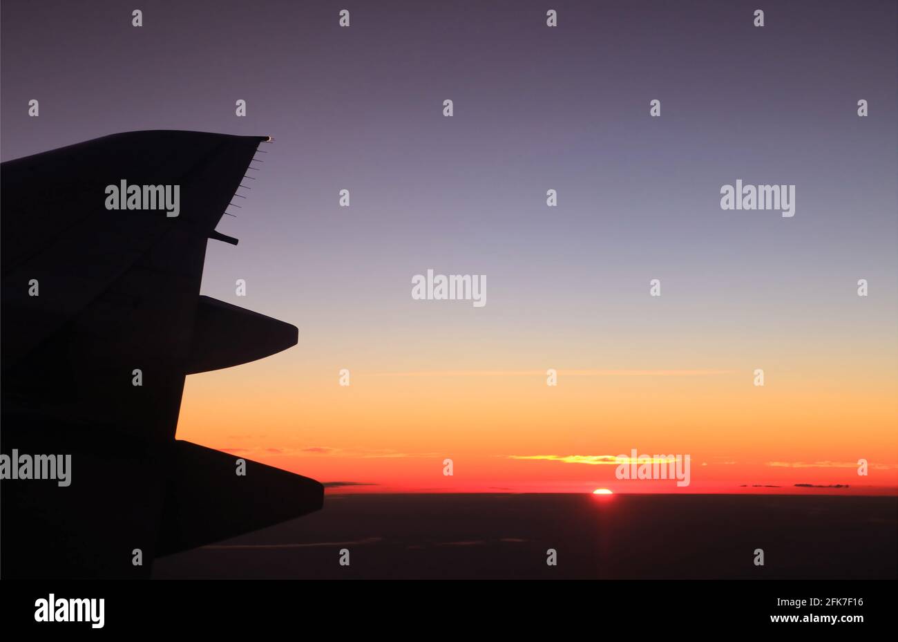 The sun rising over the sea of clouds as seen from plane window Stock ...