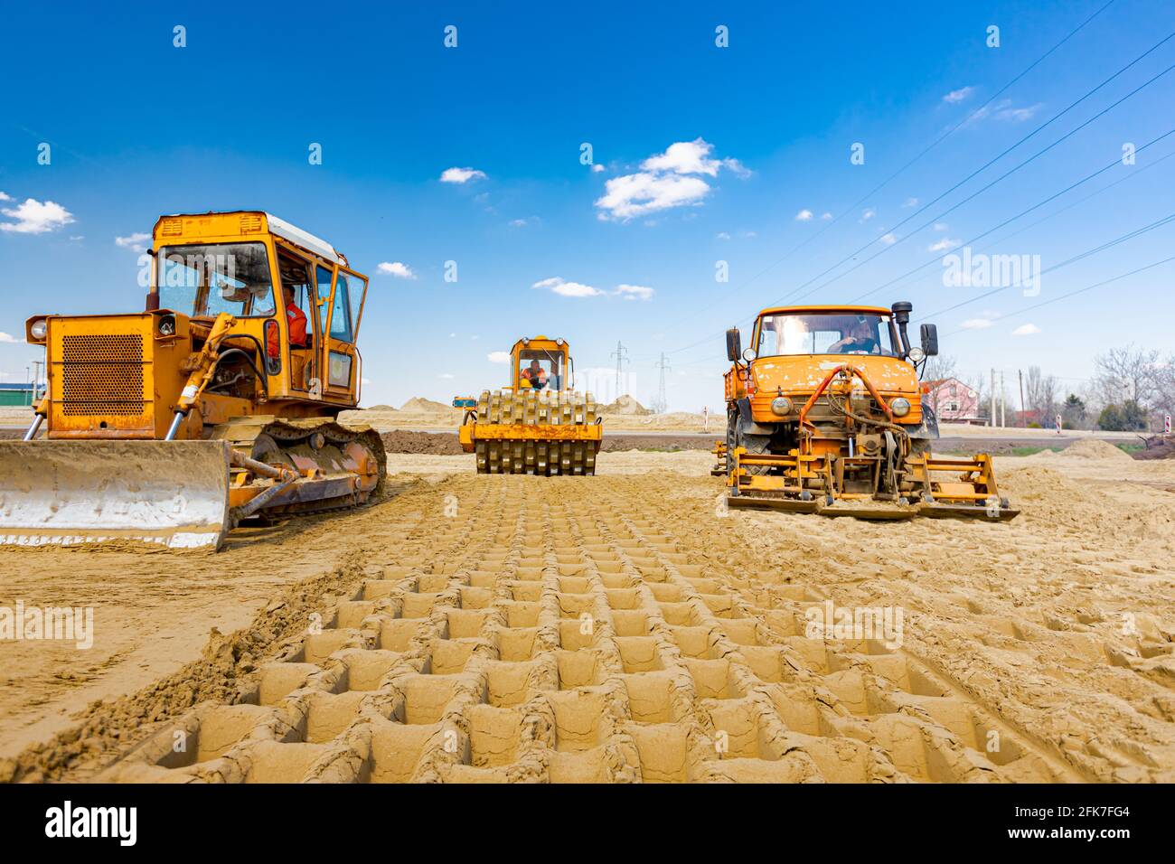 Road roller with spikes, bulldozer and truck with mounted plate ...