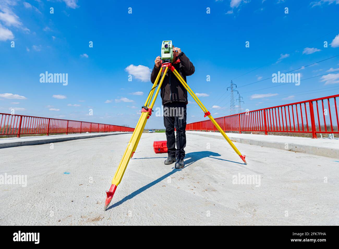 Surveyor engineer is measuring bridge under construction, site ...