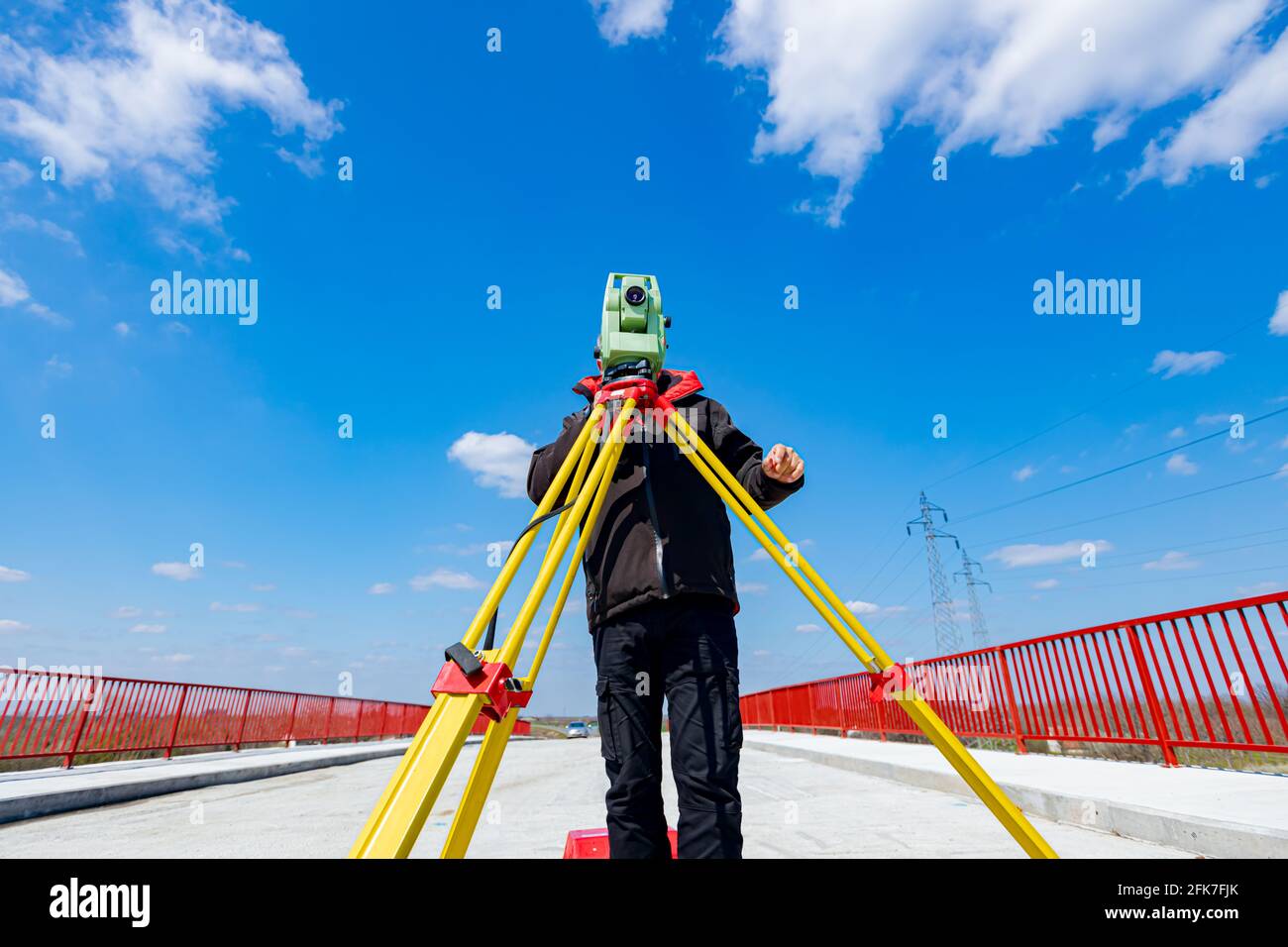 Surveyor engineer is measuring bridge under construction, site ...