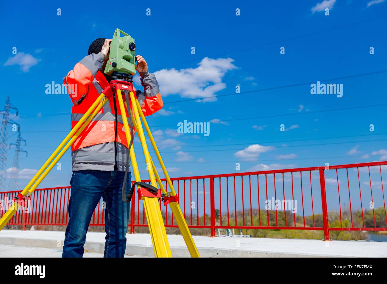 Surveyor engineer is measuring bridge under construction, site ...