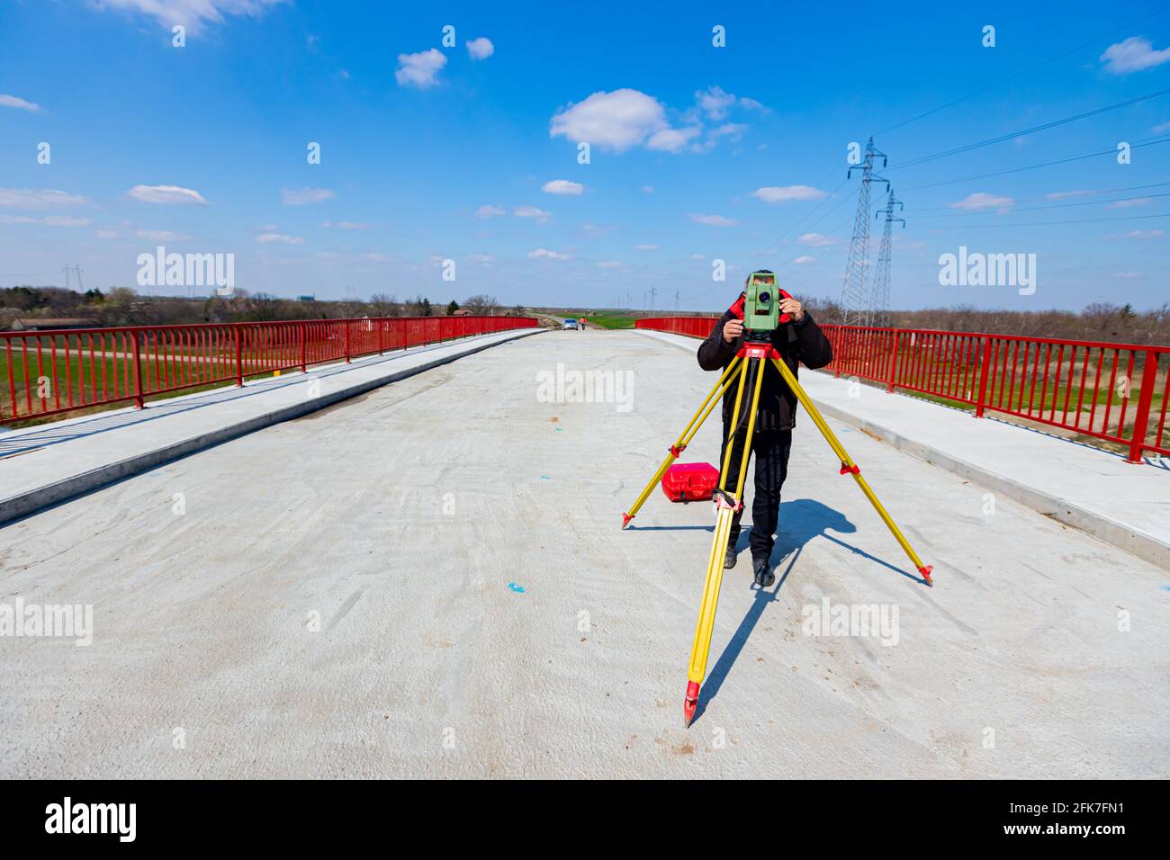 Surveyor engineer is measuring bridge under construction, site ...