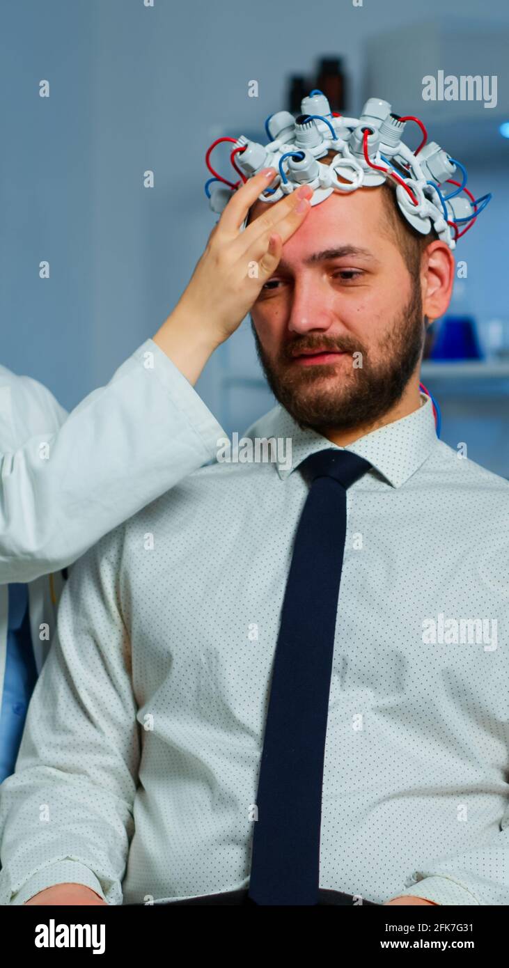 Neurologist doctor analysing brain of man and nervous system using ...