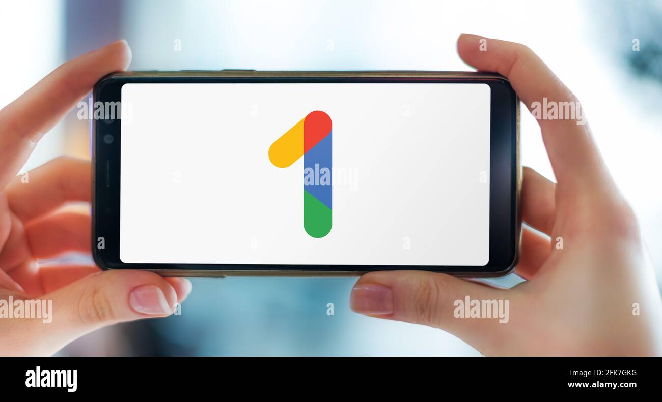 POZNAN, POL - APR 25, 2021: Hands holding smartphone displaying logo of ...