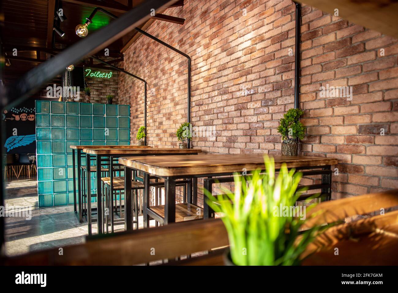 tables in a roadside cafe with a brick interior Stock Photo - Alamy