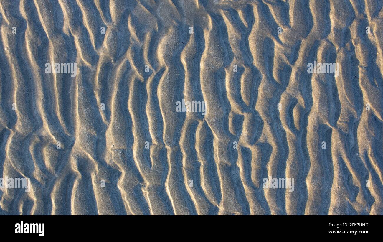 Natural sand pattern on flat sandy beach during low tide Stock Photo ...