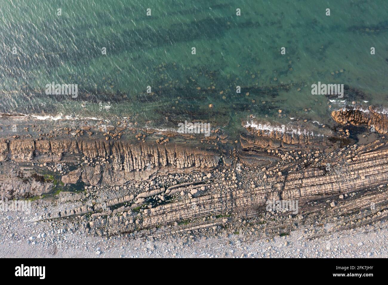 Aerial view down at the shoreline at Bucks Mills beach, North Devon ...