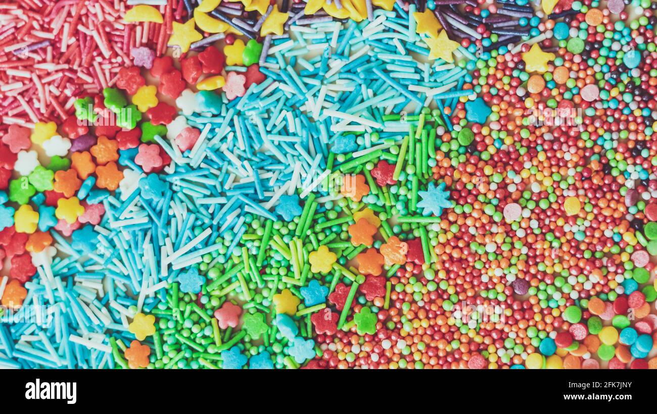 Abstract background of multicolored sugar sprinkles of different shapes ...